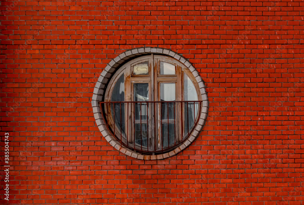 Vintage circle wooden window on a brick wall building. Architectural ...
