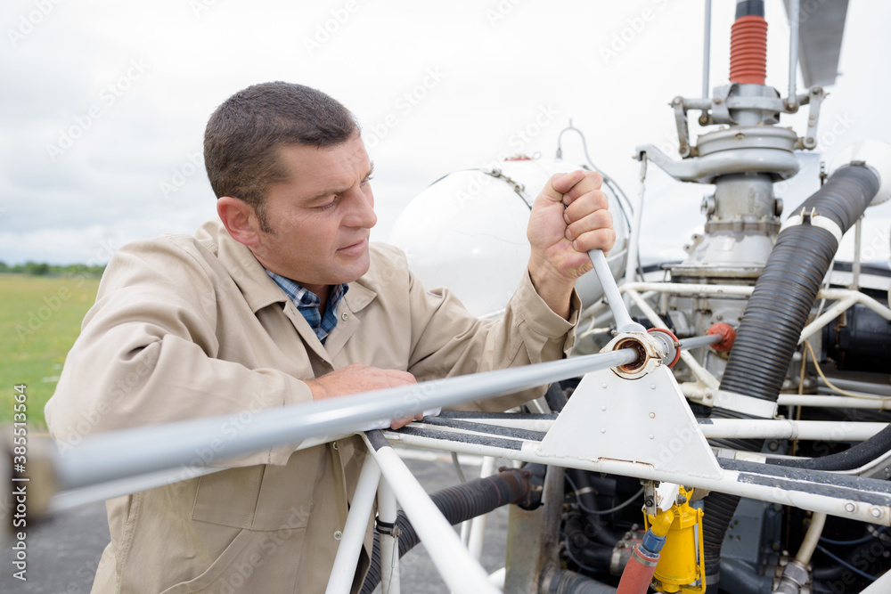 mechanic working on an aircraft outdoors on an airfield Stock Photo ...
