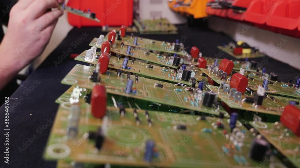 Hands inserting electronic component into printed circuit board ... Hands inserting electronic component into printed circuit board ...