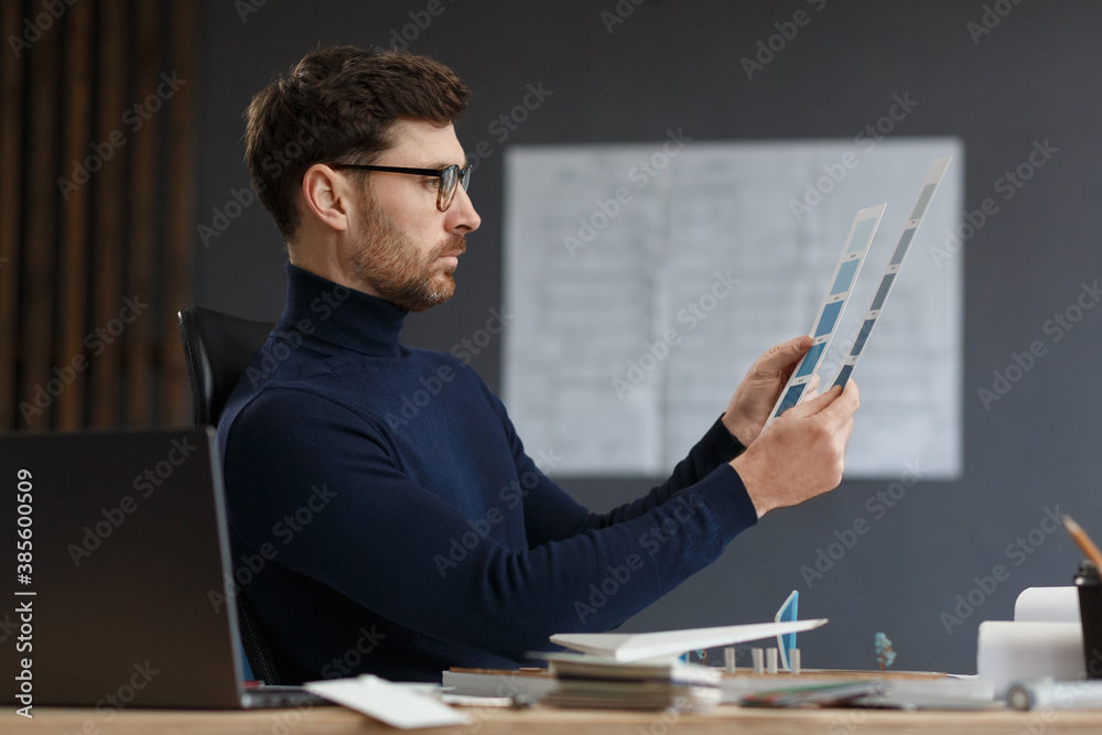 Architect working in office with color palette. Engineer select colors ...
