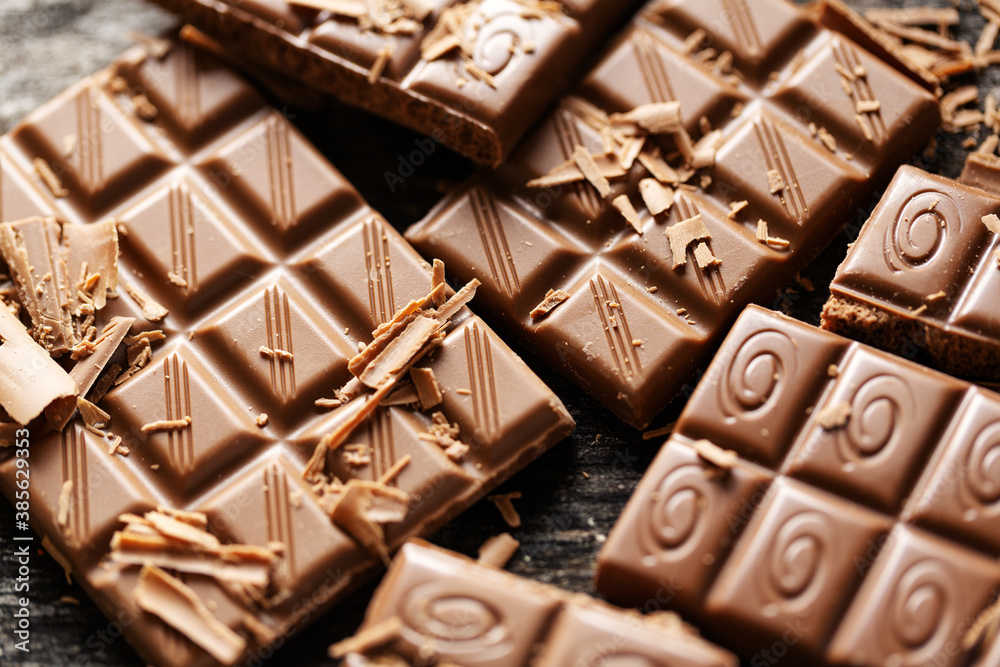 Broken chocolate bars on dark background Stock Photo | Adobe Stock