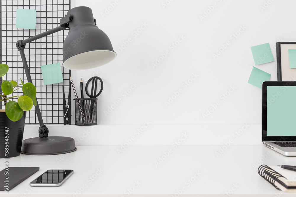 Office creative desk with lamp notice board, blank notes and wall ...