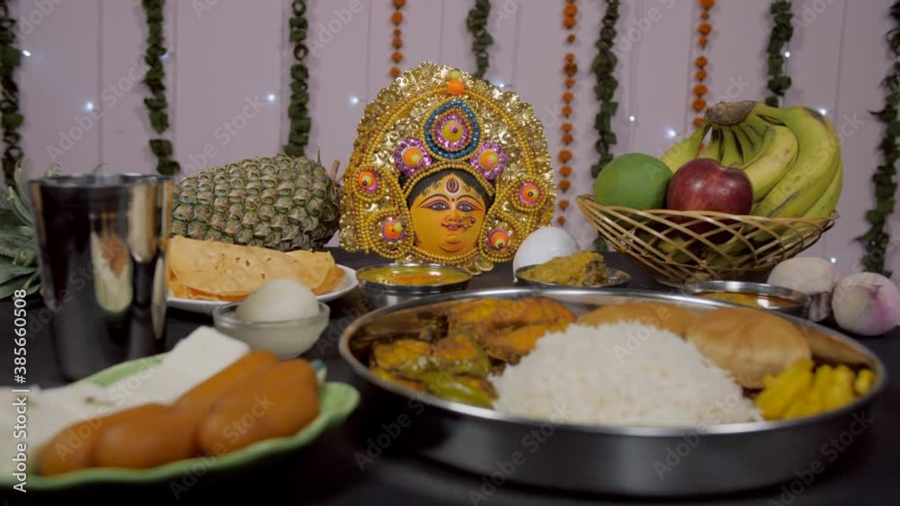 Religious Bengali female keeping a plate of Papad before Devi Durga as ...