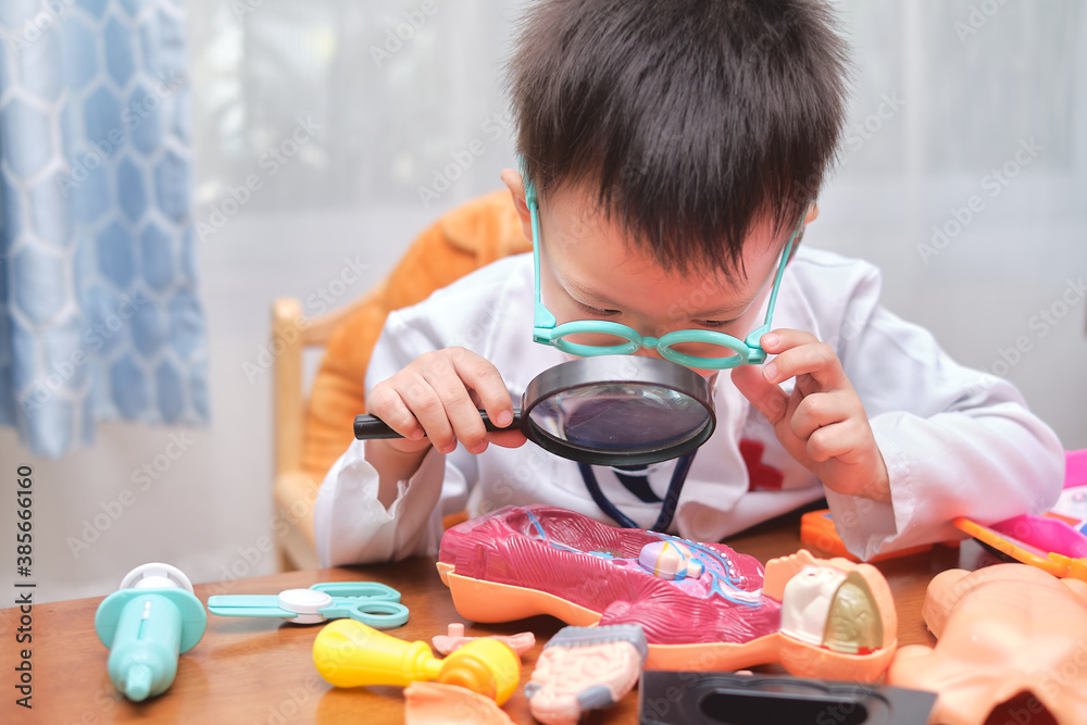 Asian school boy in doctor uniform playing doctor at home, kid wearing ...