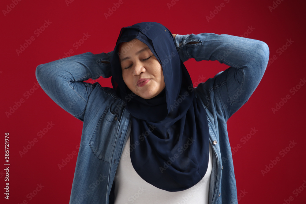 Beautiful Asian muslim woman stretching back, tired and relaxed, sleepy ...