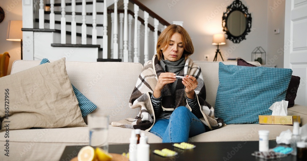 Caucasian pretty sick woman with thermometer not feeling well and ...