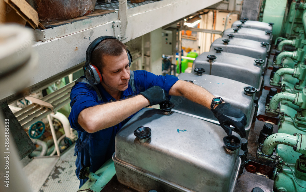 Marine engineer officer reparing vessel engines and propulsion in ...