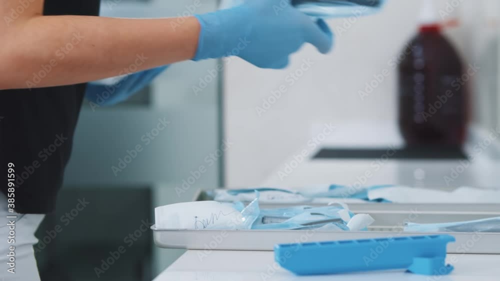 Female assistant young doctor preparing and laying out dental ...