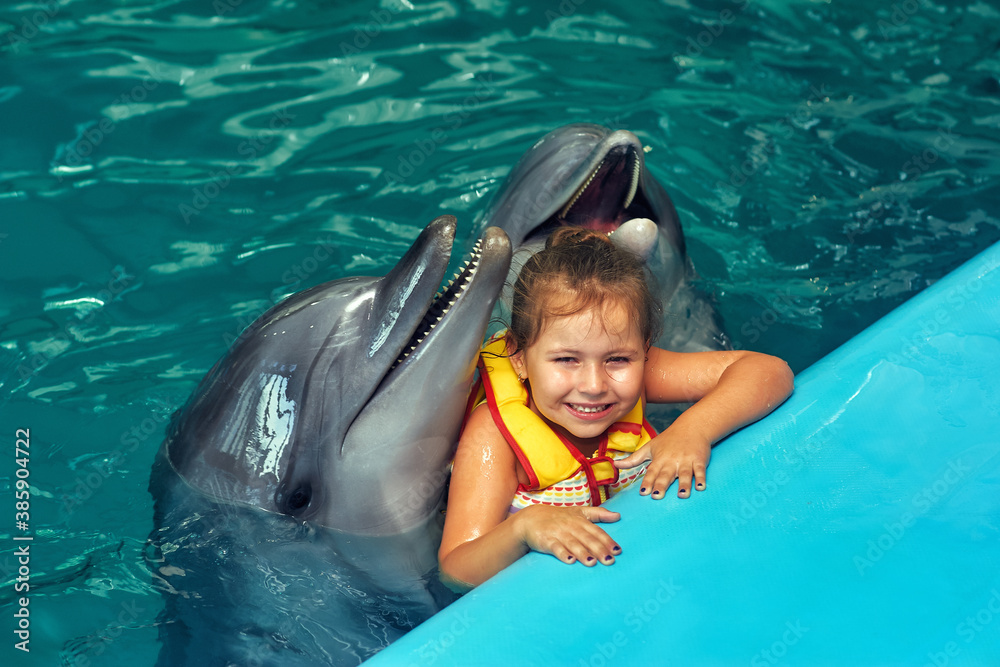 Little girl on therapeutic procedures in the pool with dolphins Stock ...