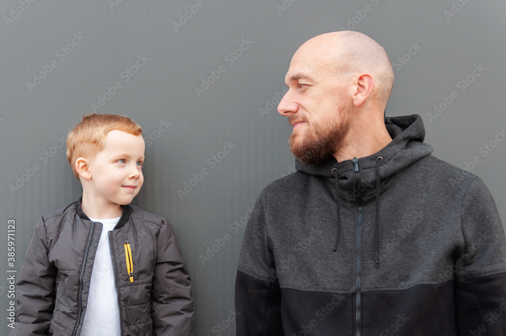Minimalism style. Side view of handsome father and his cute son looking ...