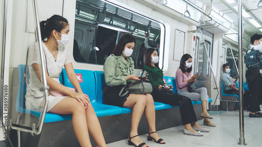 Crowd of people wearing face mask on a crowded public subway train ...