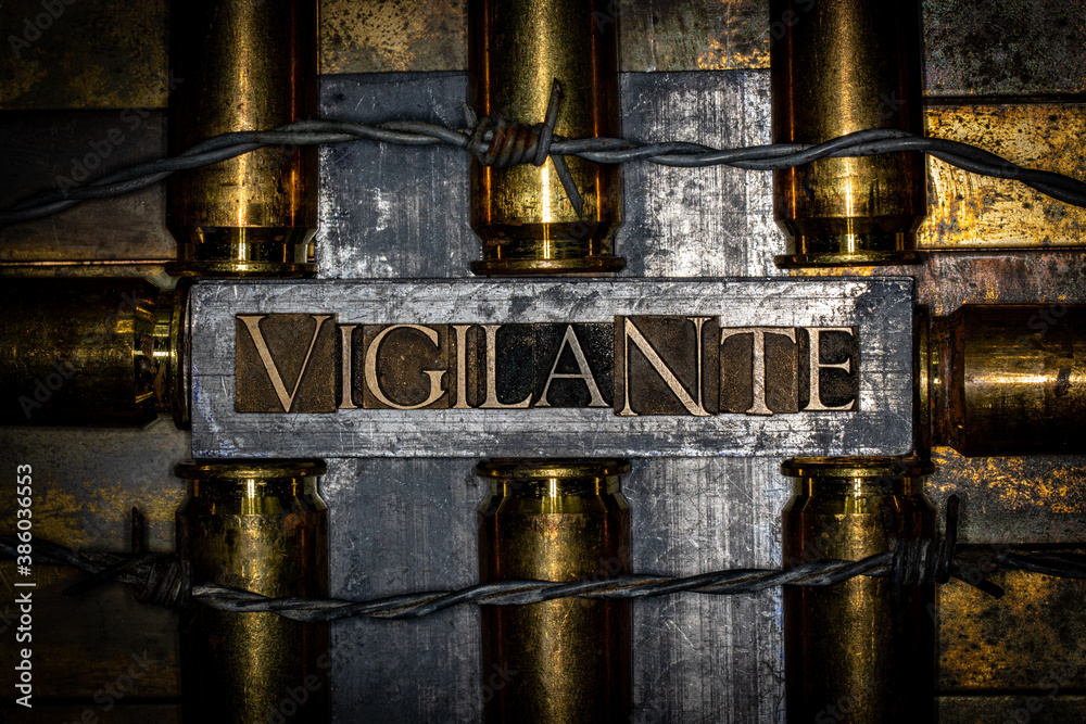 Vigilante text message on lead bar between copper 50 caliber gun ...