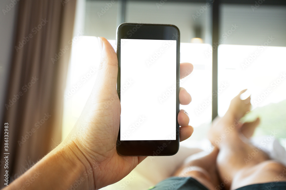Close up image of man’s hand holding mobile phone with blank white ...