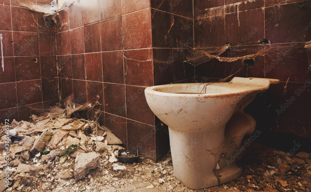 Old rusty dirty toilet in abandoned house, ceramic clogged wc leaned to ...