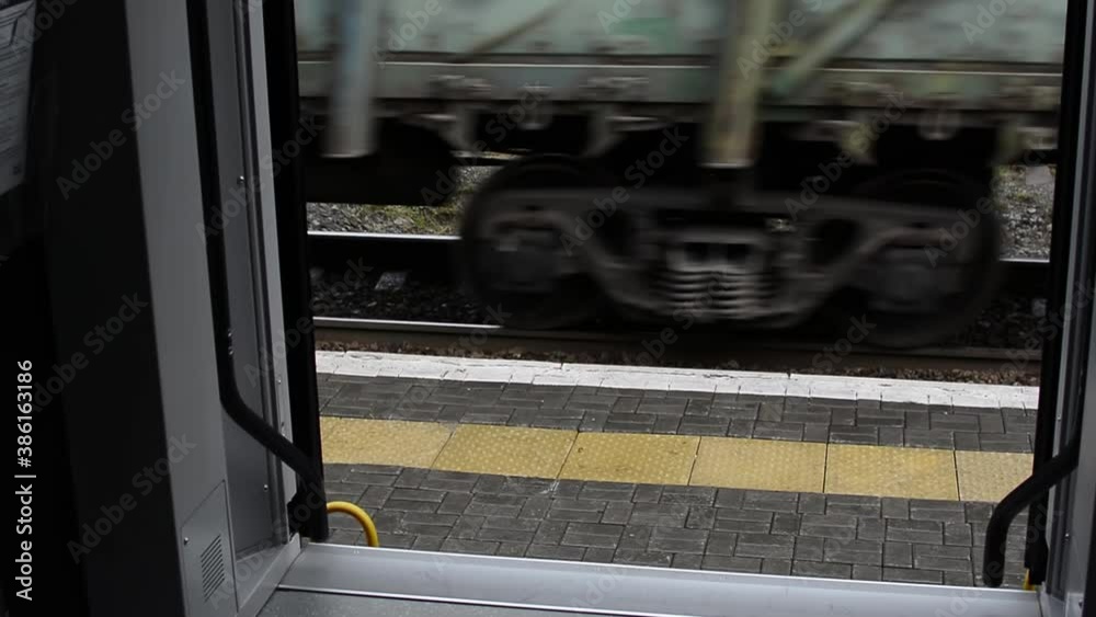 A view from the floor of a freight train carriage along the adjacent ...