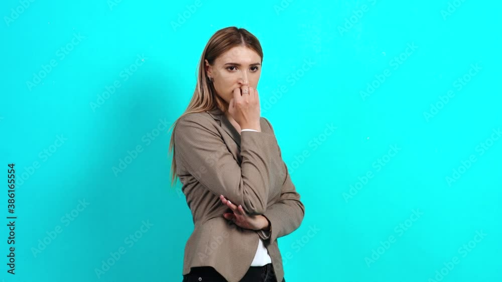 Extremely nervous adult woman in horror, in business jacket, biting her ...