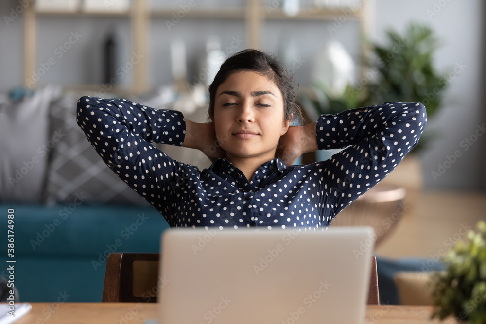 Relaxed indian woman finished work closed eyes taking break sit at desk ...