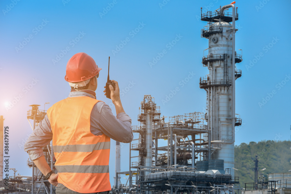 Worker in Oil Refinery discussion and control operation inspection by ...