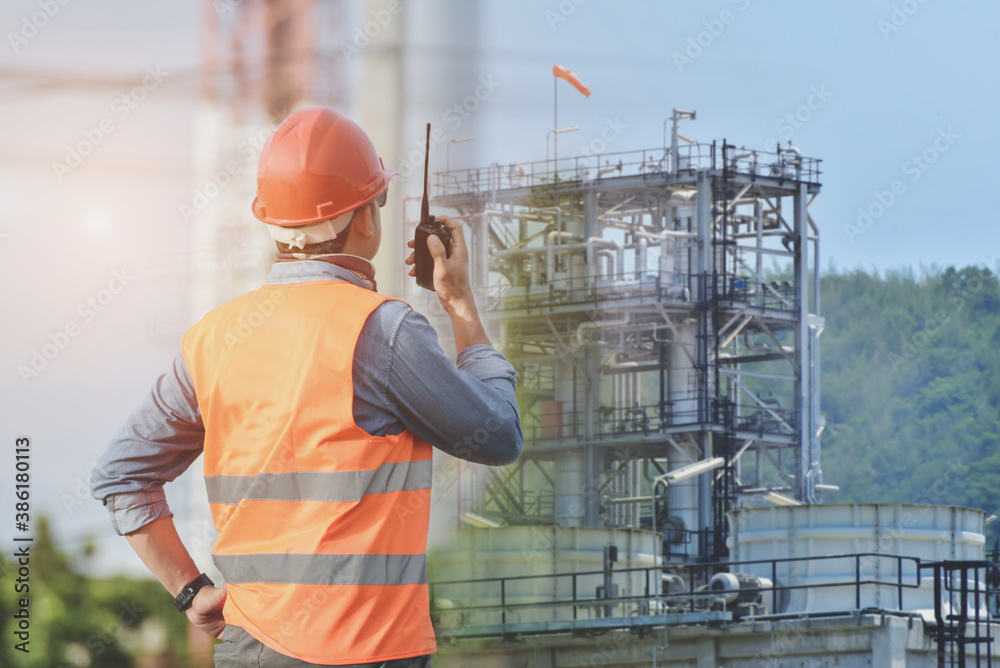 Refinery worker discussion and pointing for inspection by hand holding ...