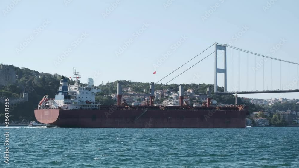 A red tanker ship was passing under The Fatih Sultan Mehmet Bridge at ...