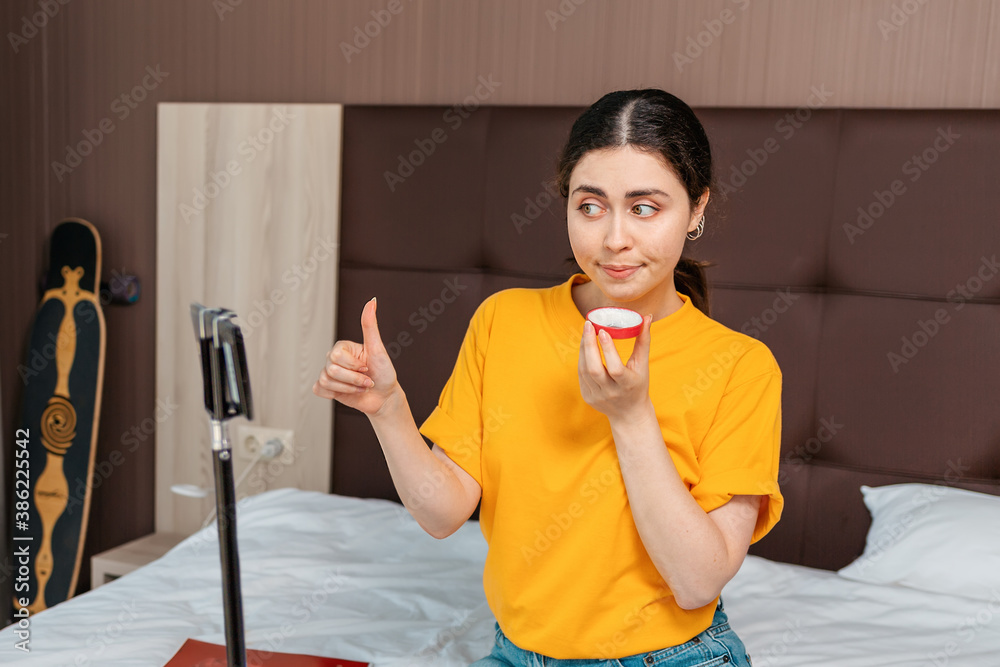 Portrait of pretty female vlogger streaming a live video to her ...