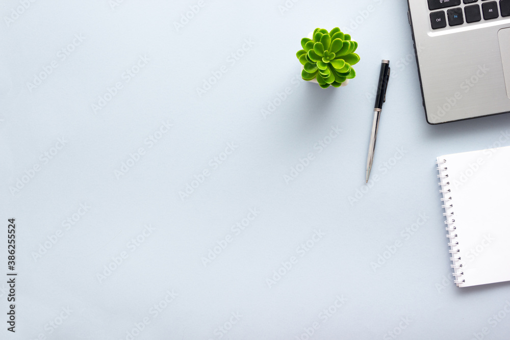 Blue desk office with laptop, smartphone and other work supplies with ...