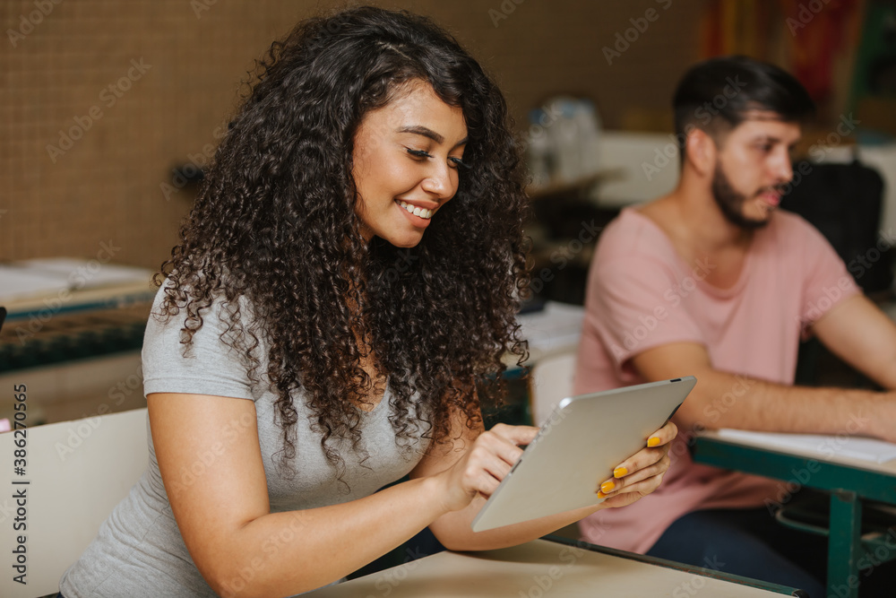 Latin students in the classroom. smiling female curly hair student ...