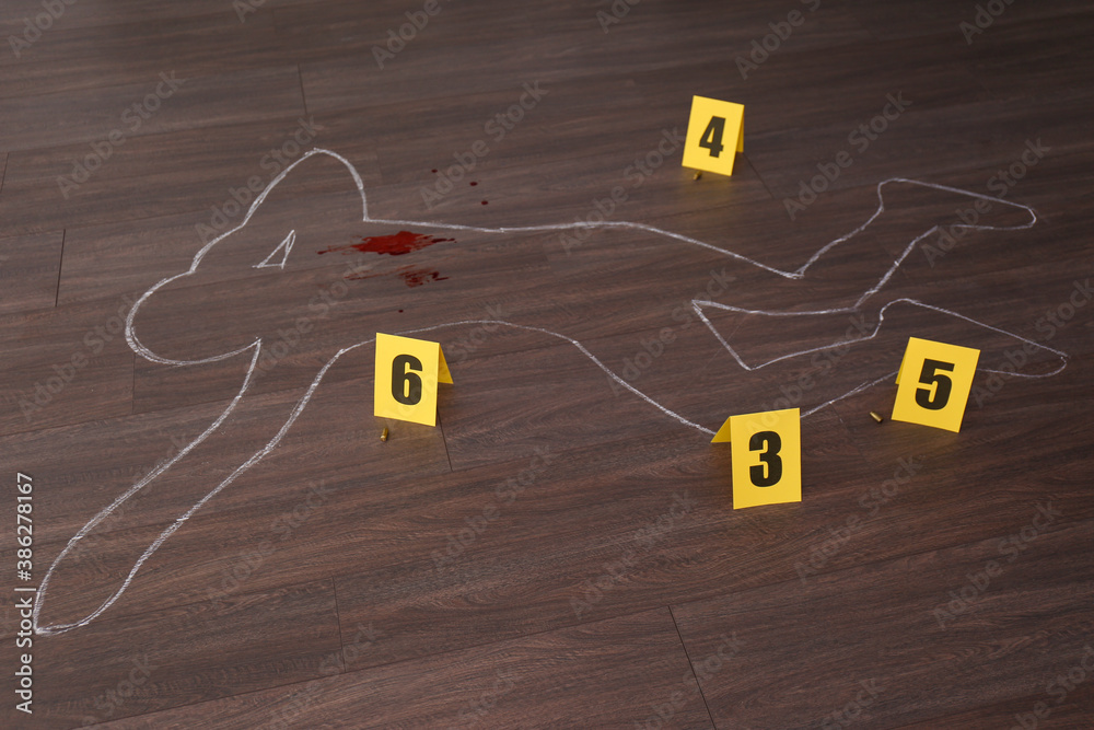 Crime scene with chalk outline of human body, blood, bullet shells and ...