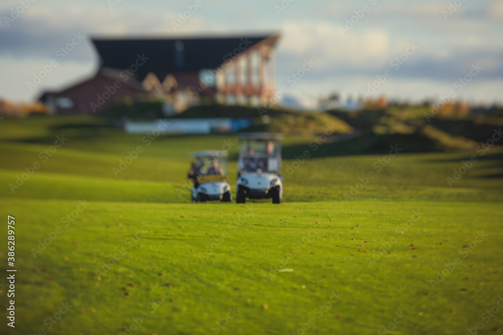 Golf electric cars riding on a golf course in the sunny day, golf carts ...