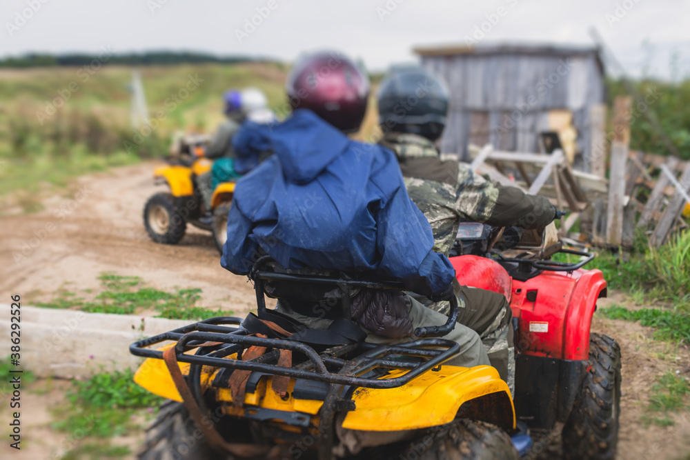 Group of riders riding atv vehicle on off road track, process of ...