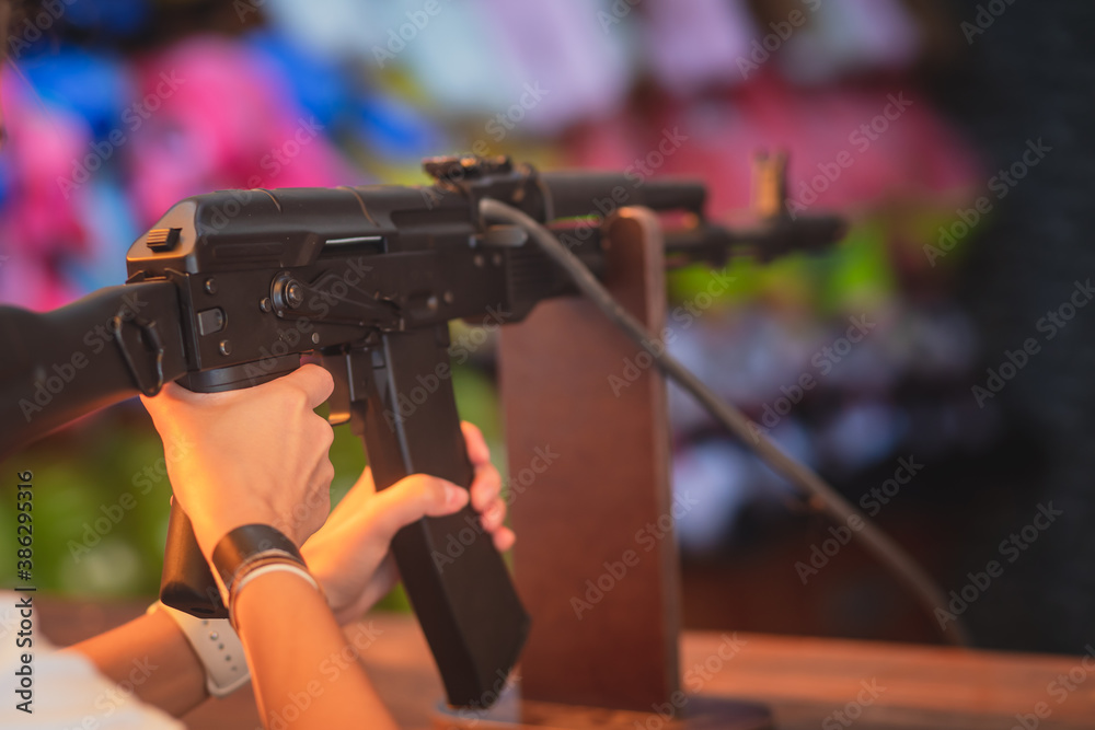 People aiming and shooting in target at a shooting firing range gallery ...