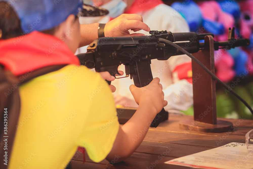 People aiming and shooting in target at a shooting firing range gallery ...