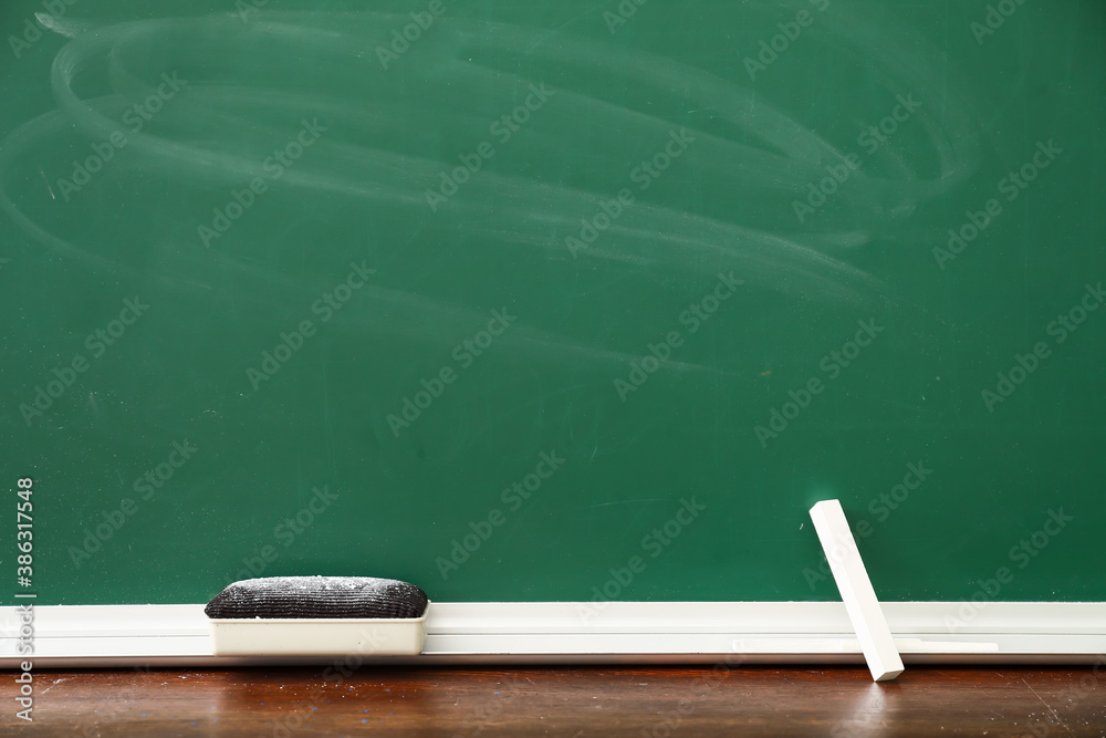 Chalk with sponge and blackboard in classroom Stock Photo | Adobe Stock
