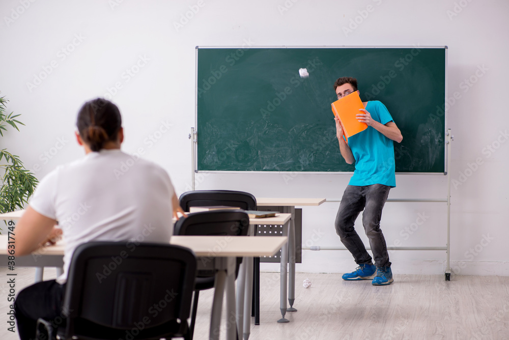Two male pupils in bullying concept in the classroom Stock Photo ...