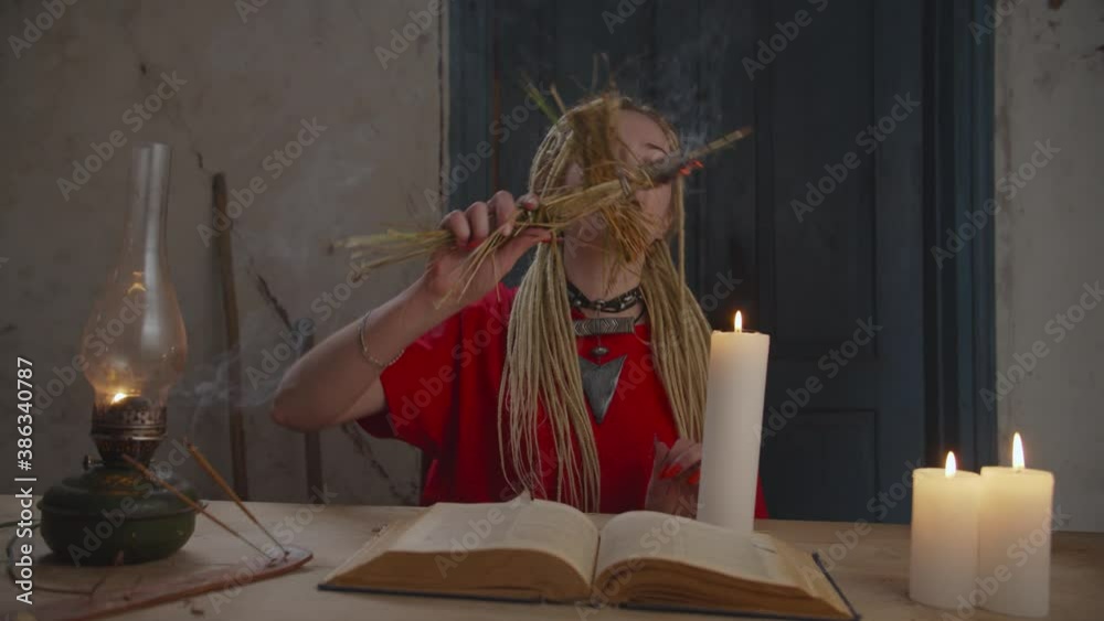 Ruthless evil charming voodoo witch with dreadlocks practicing black ...