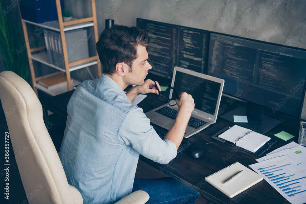 Profile side high angle view photo of focused guy it specialist sit ...