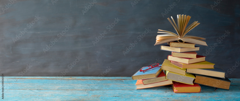 open book on a stack of books, reading, education, home office concept ...
