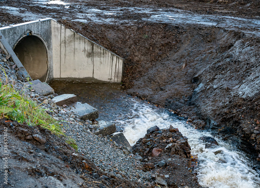 Newly constructed drainage ditch with concrete sewage pipes to guide ...