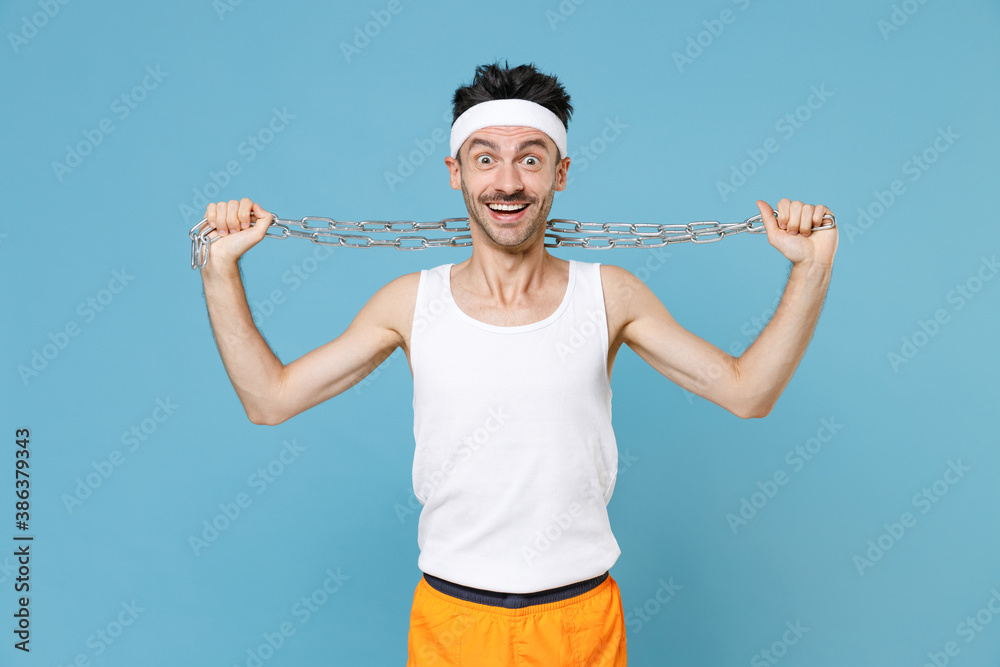 Excited cheerful young strong fitness man with thin skinny body ...
