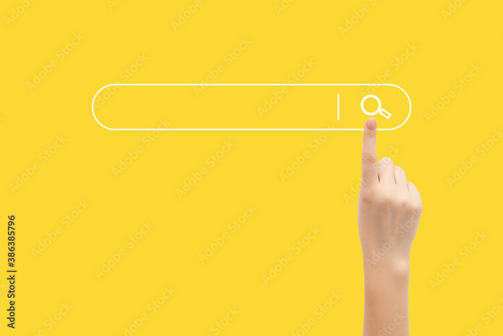 Finger presses the search button in the search bar on a yellow ...