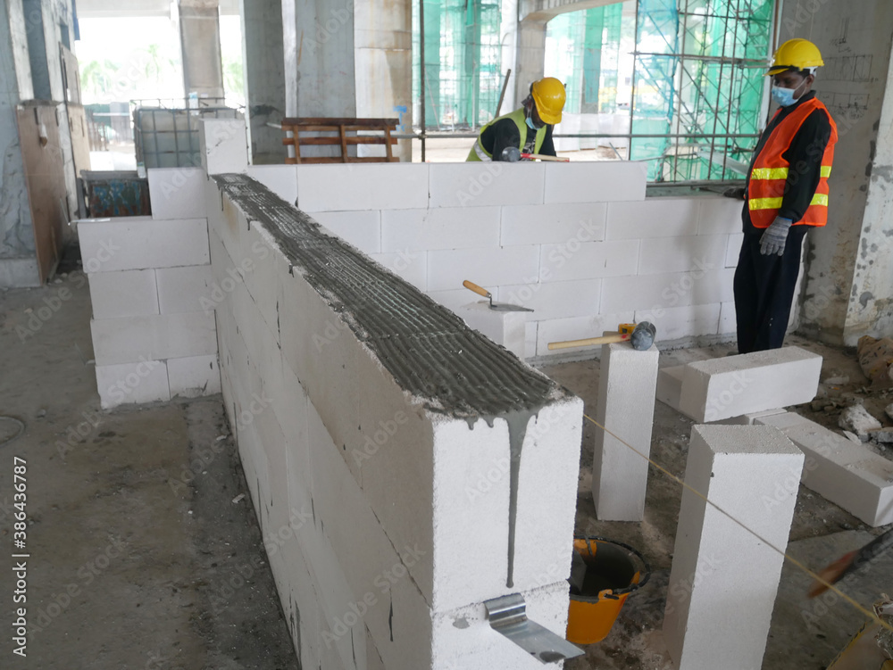 SEREMBAN, MALAYSIA -MARCH 16, 2020: Construction workers laying ...