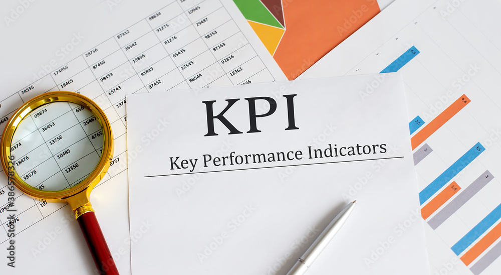 KPI Key Performance Indicator text with magnifying glass lens on office ...
