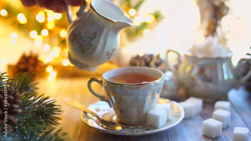 Vídeo do Stock: Milk is poured into traditional English tea in a cup ...