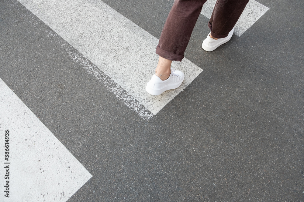 female feet crossing the crosswalk Stock Photo | Adobe Stock
