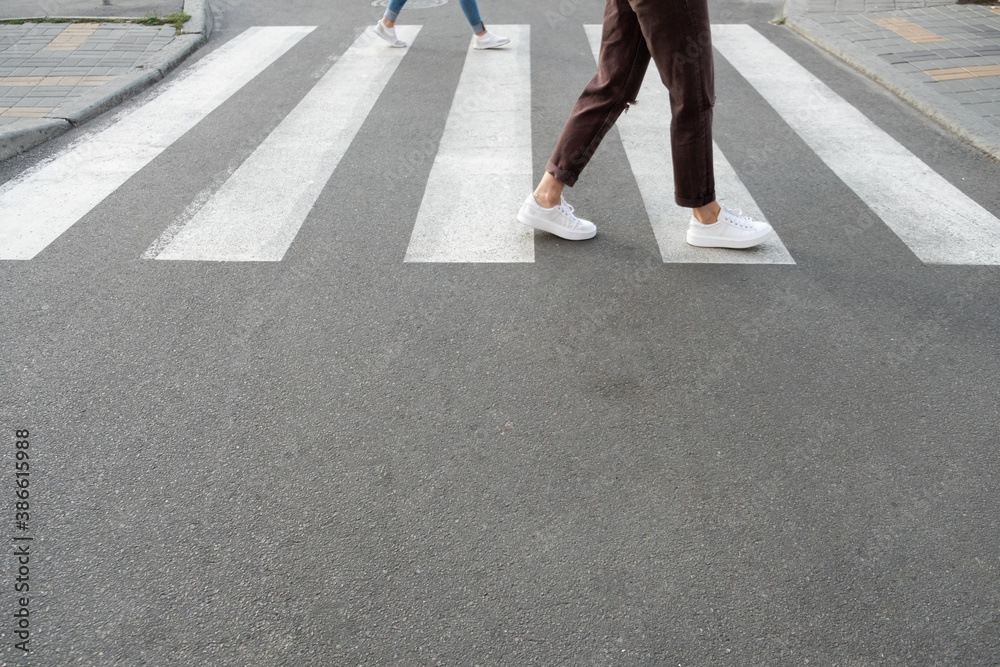 female feet crossing the crosswalk Stock Photo | Adobe Stock
