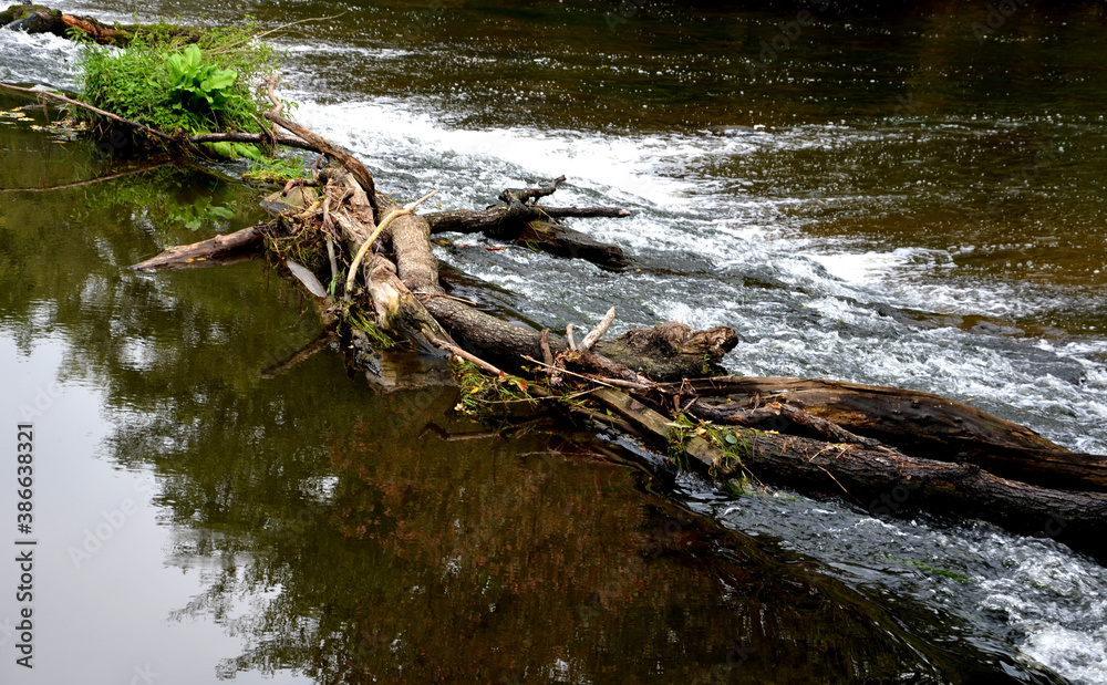 long dangerous weir on the river after the flood. barrage barred ...