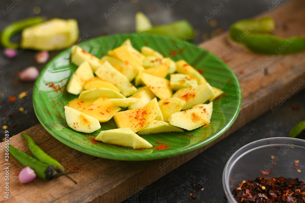 Sliced green mango with chili powder , salt street food snack Kerala ...