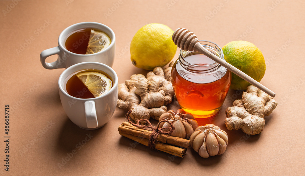 Natural cold and flu home remedies: hot tea cups with lemon, honey ...