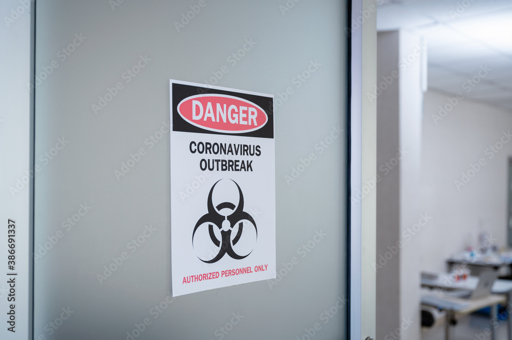 Alert notice on the door of danger coronavirus outbreak with biohazard ...