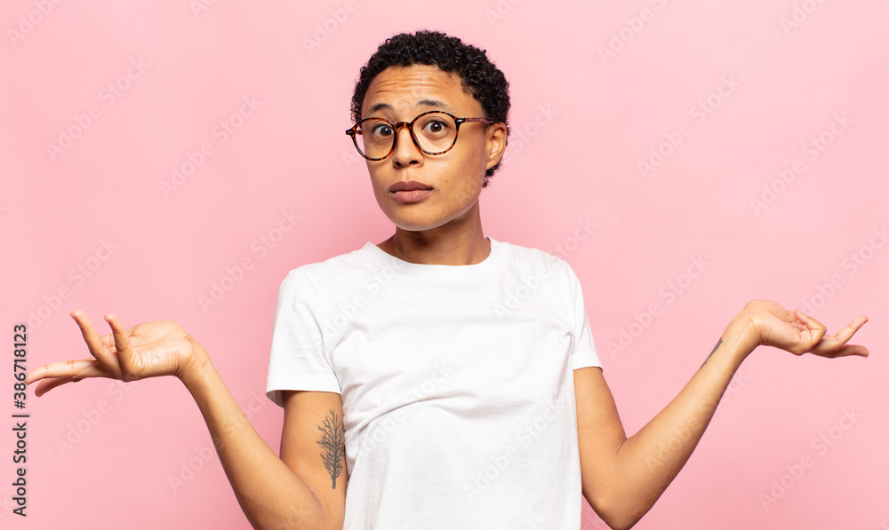 afro young black woman looking puzzled, confused and stressed ...